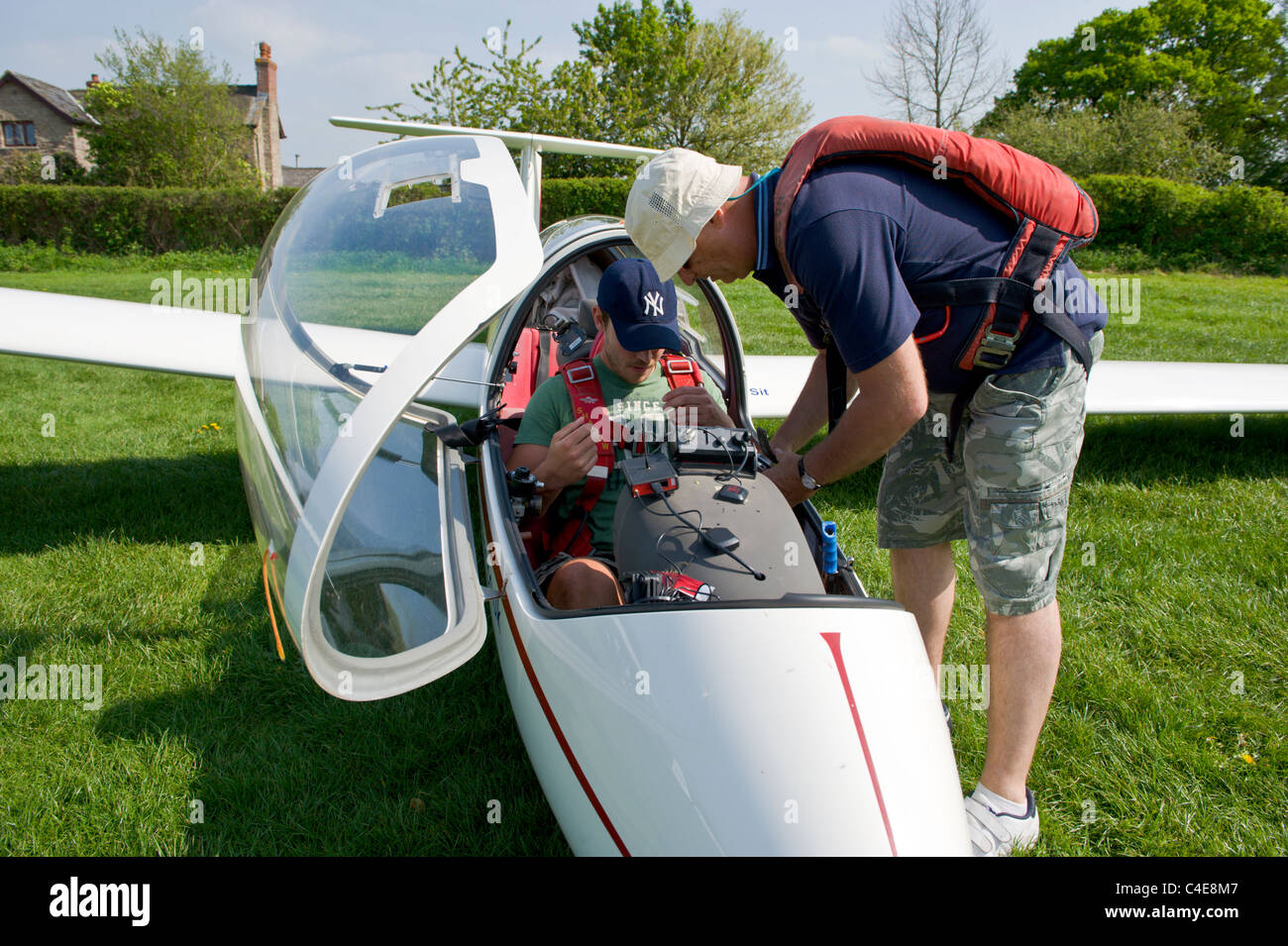 Young man receiving instruction on cockpit layout before having first ...