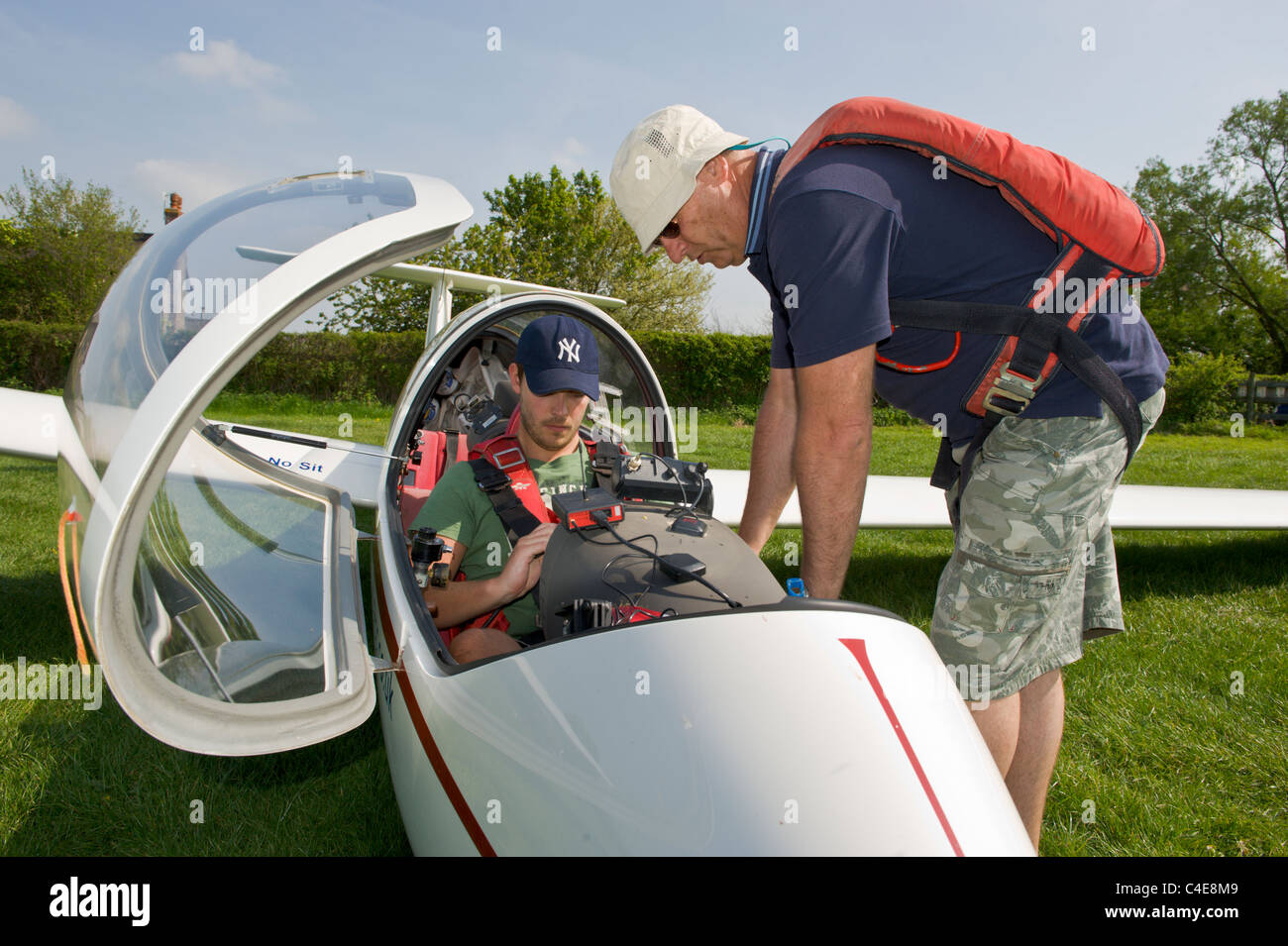 Young man receiving instruction on cockpit layout before having first ...