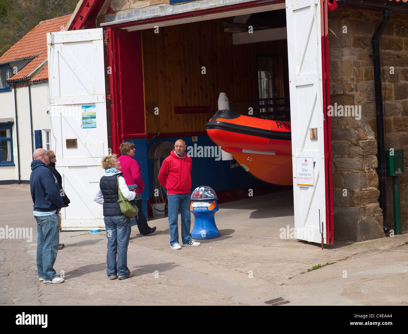 Tourists looking at the RNLI lifeboat semi rigid fast rescue craft at ...