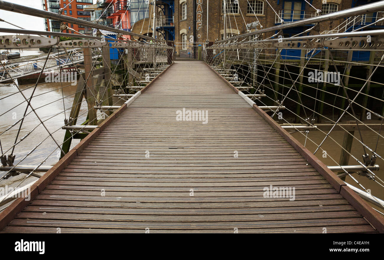 An old iron bridge entrance to St. Savior's Dock, Shad Thames, London ...