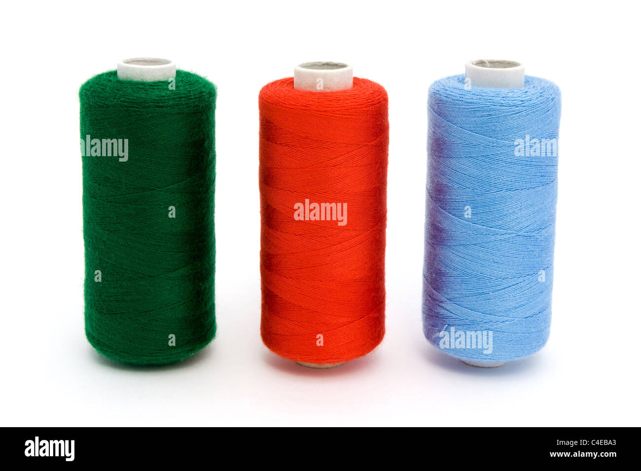 Three rolls of different colour cotton isolated on white Stock Photo ...