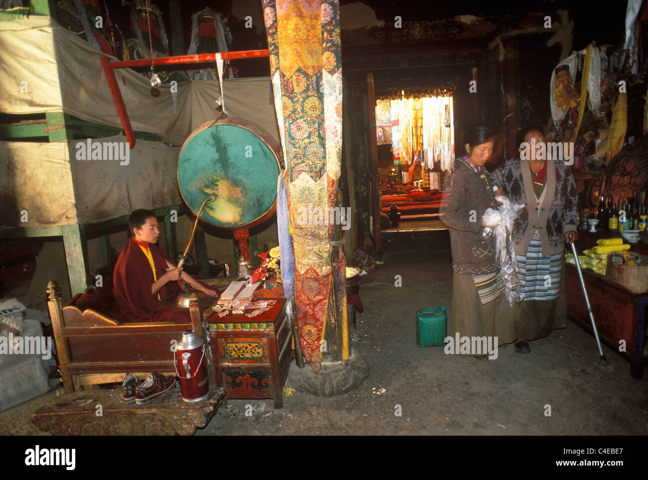 Monk beating drum in the Gonkhang, Utse. Samye Monastery was the first ...