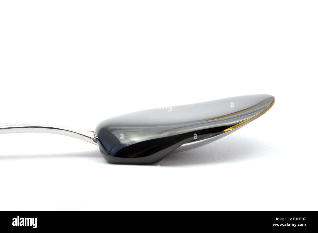 Sugar beet molasses on spoon Stock Photo - Alamy