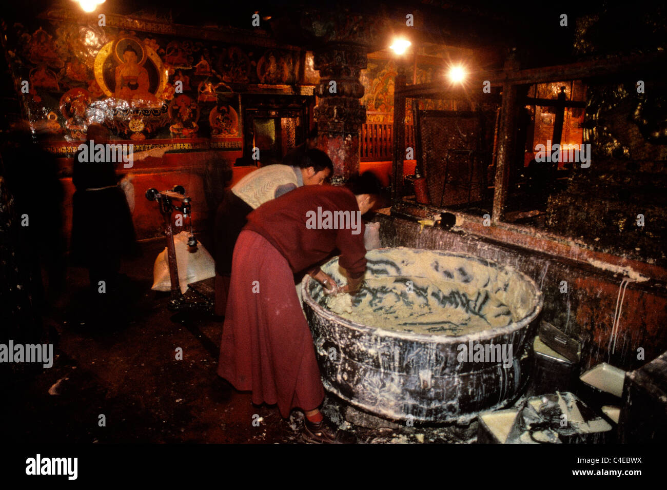 Tibetan monks churning yak butter for candles in the Jokhang, Lhasa ...