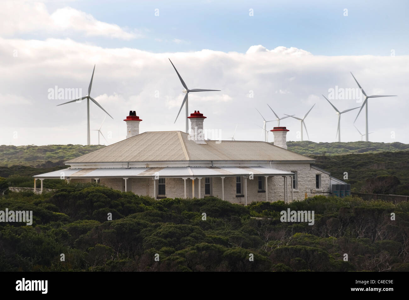 wind generators behind old house Stock Photo - Alamy