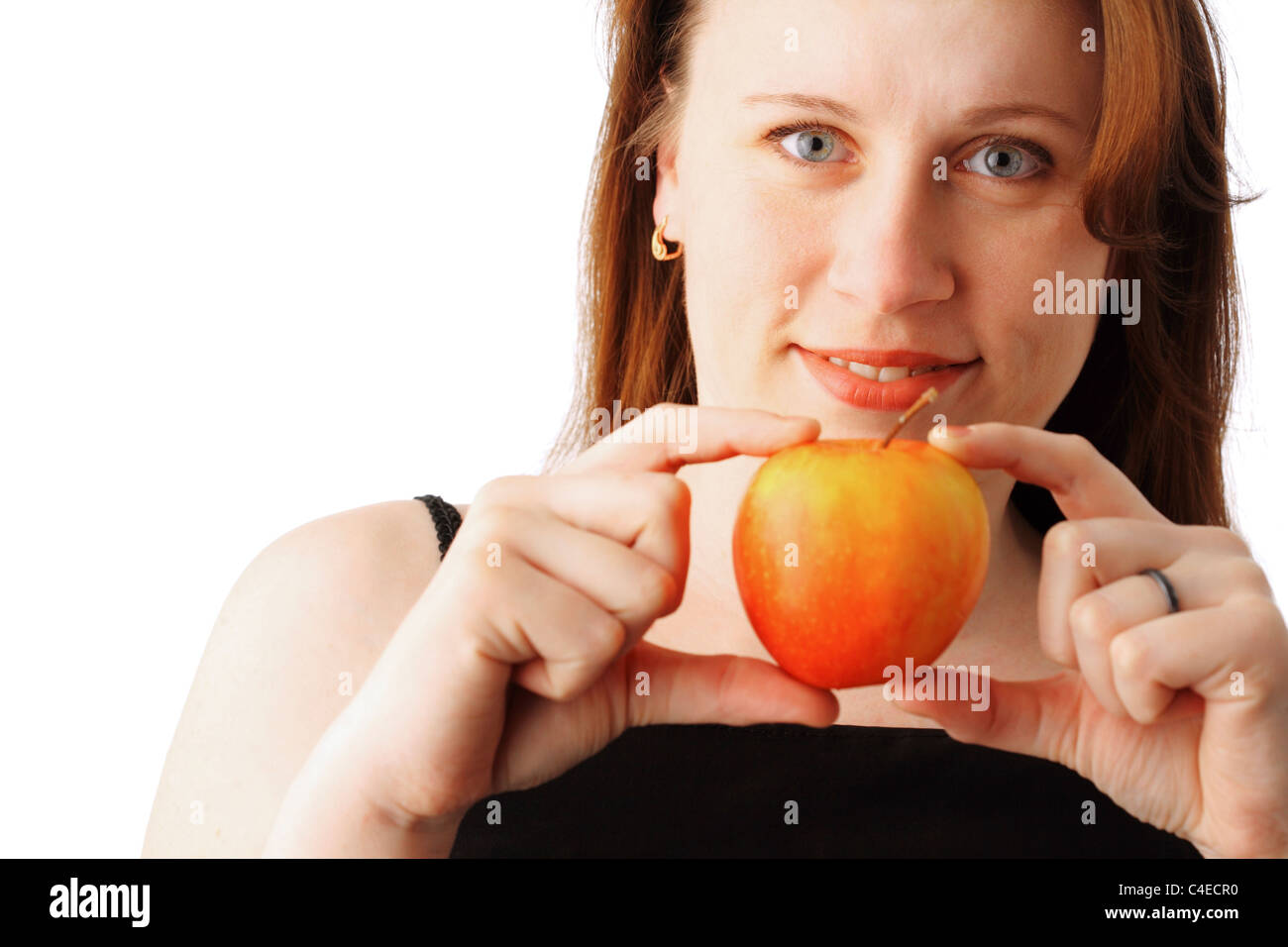 Closeup portrait of a young pretty woman holding a red apple in her ...