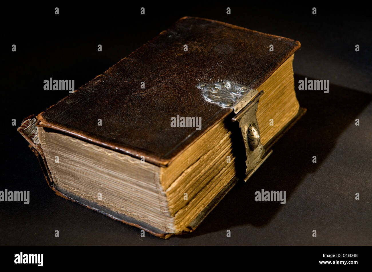 Nice old bible with an old lock on a black background Stock Photo - Alamy
