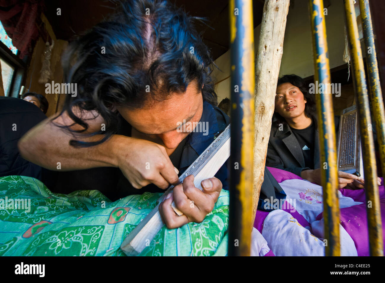 Hand carving the wooden printing block of classic Tibetan texts at Dege ...
