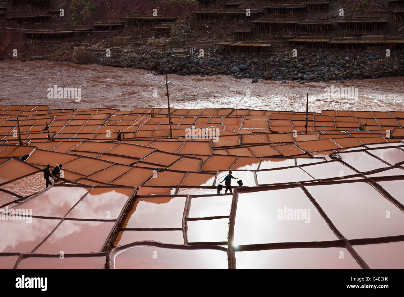 Salt wells and drying pans raised on stilts, on the banks of the Mekong ...