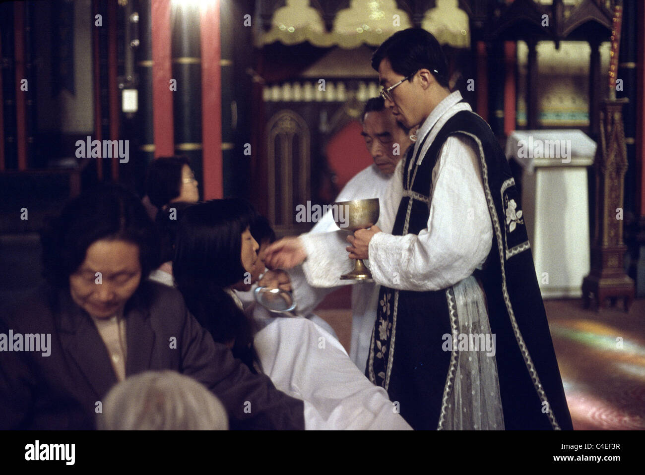 Chinese women receiving the host in Holy Communion in a Roman Catholic ...