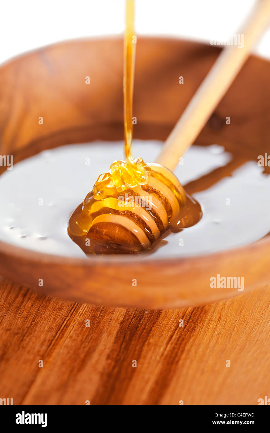 Wooden dipper and bowl of fresh honey. Shallow depth of field Stock ...