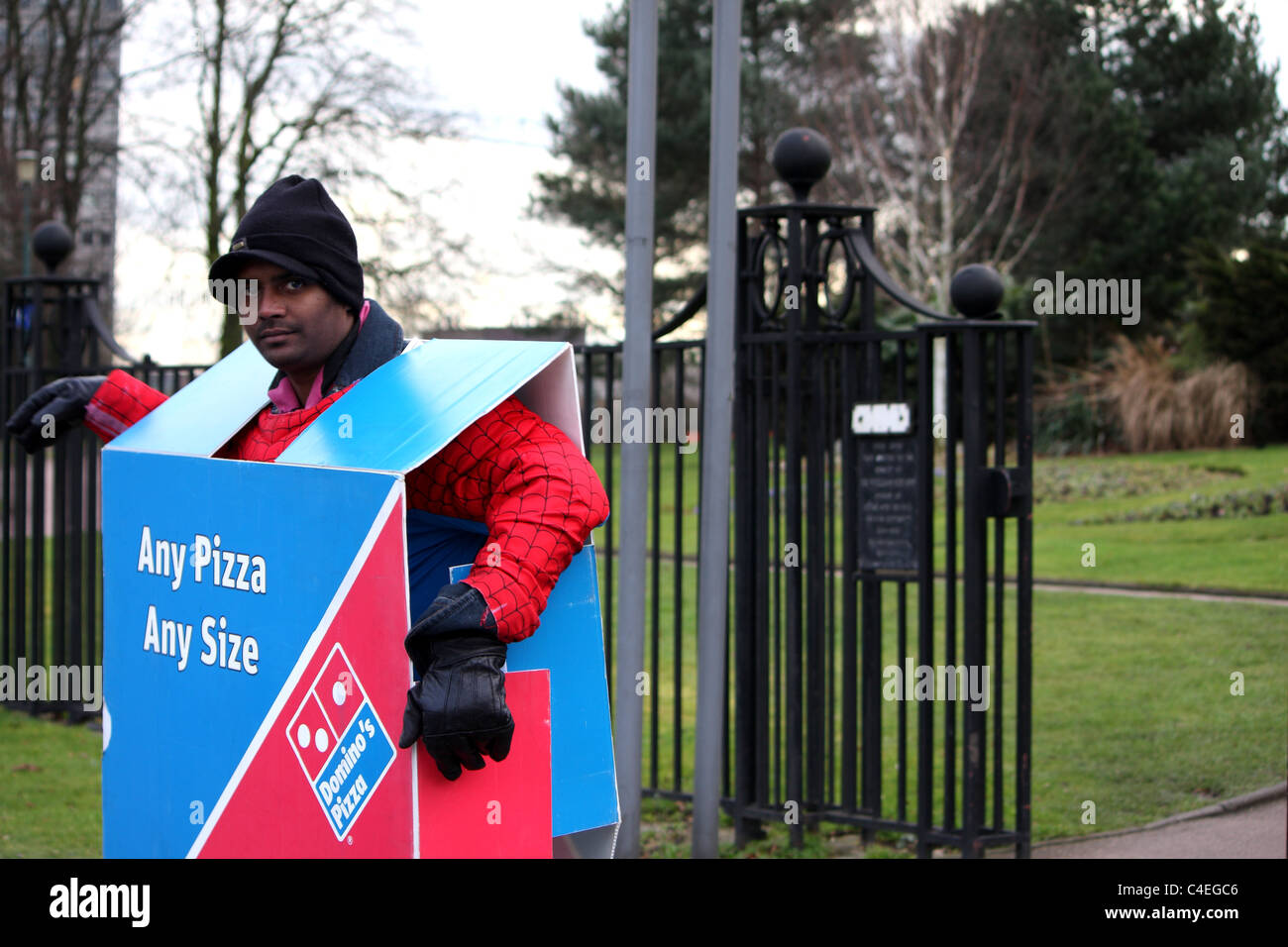 An Asian male advertising Dominos Pizza walking around with a display ...