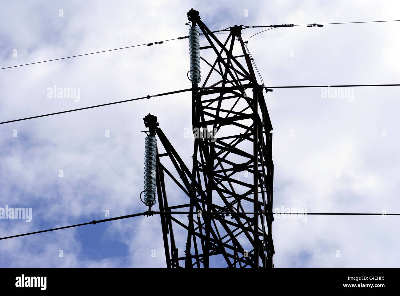Electricity pylons with long cable at day Stock Photo - Alamy