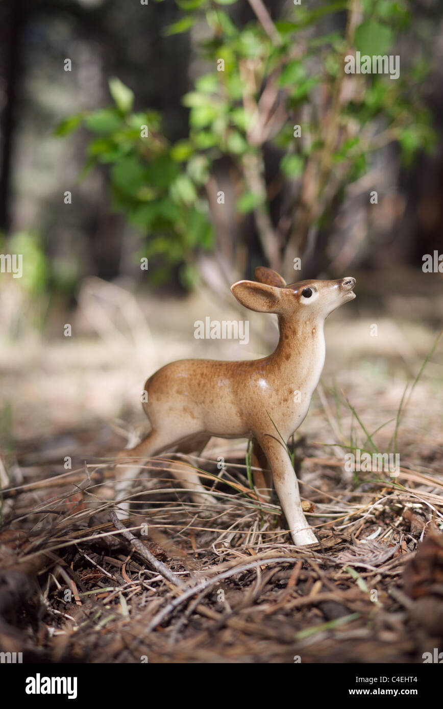 Small deer figurine in woods Stock Photo - Alamy
