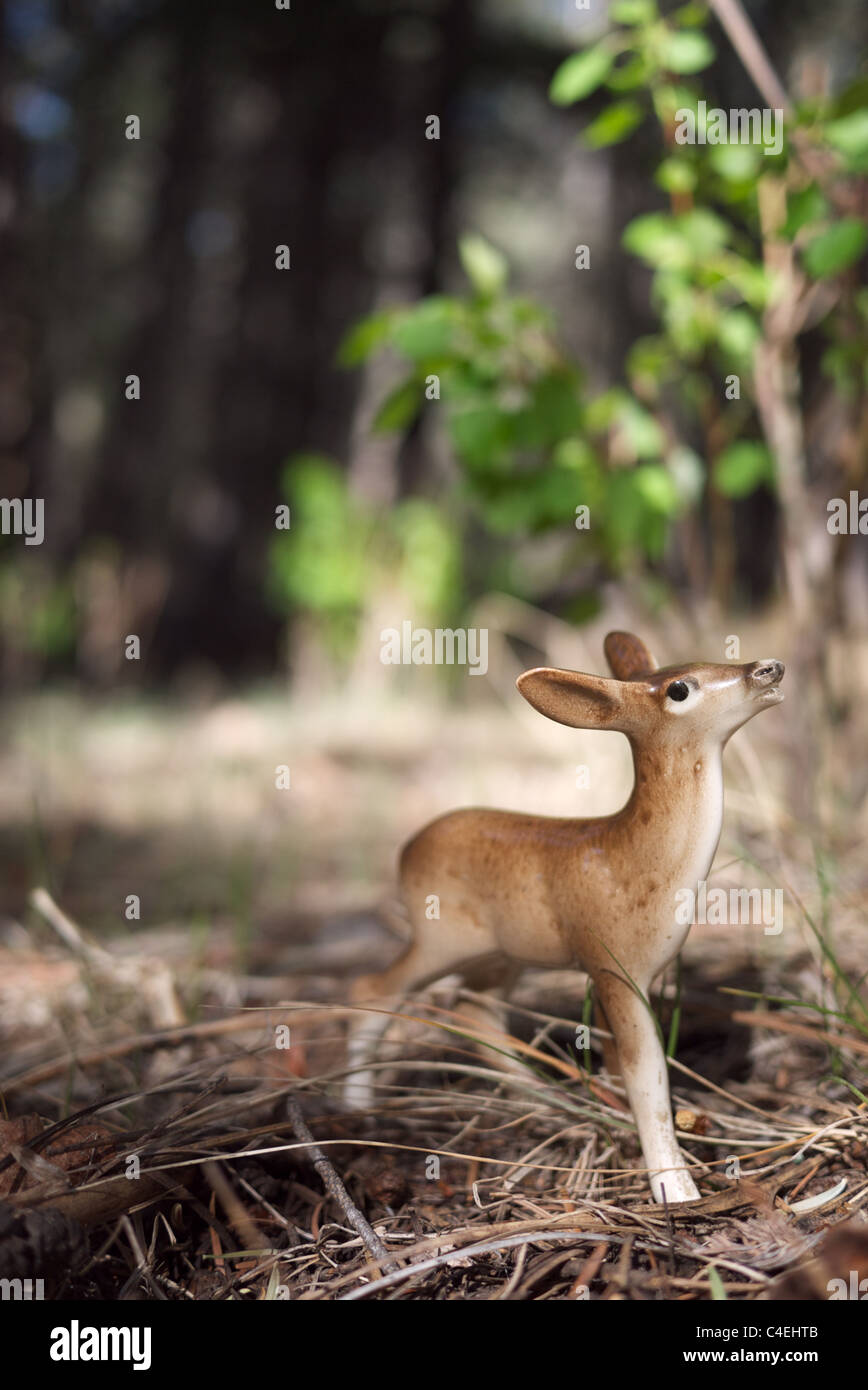 Small deer figurine in woods Stock Photo - Alamy