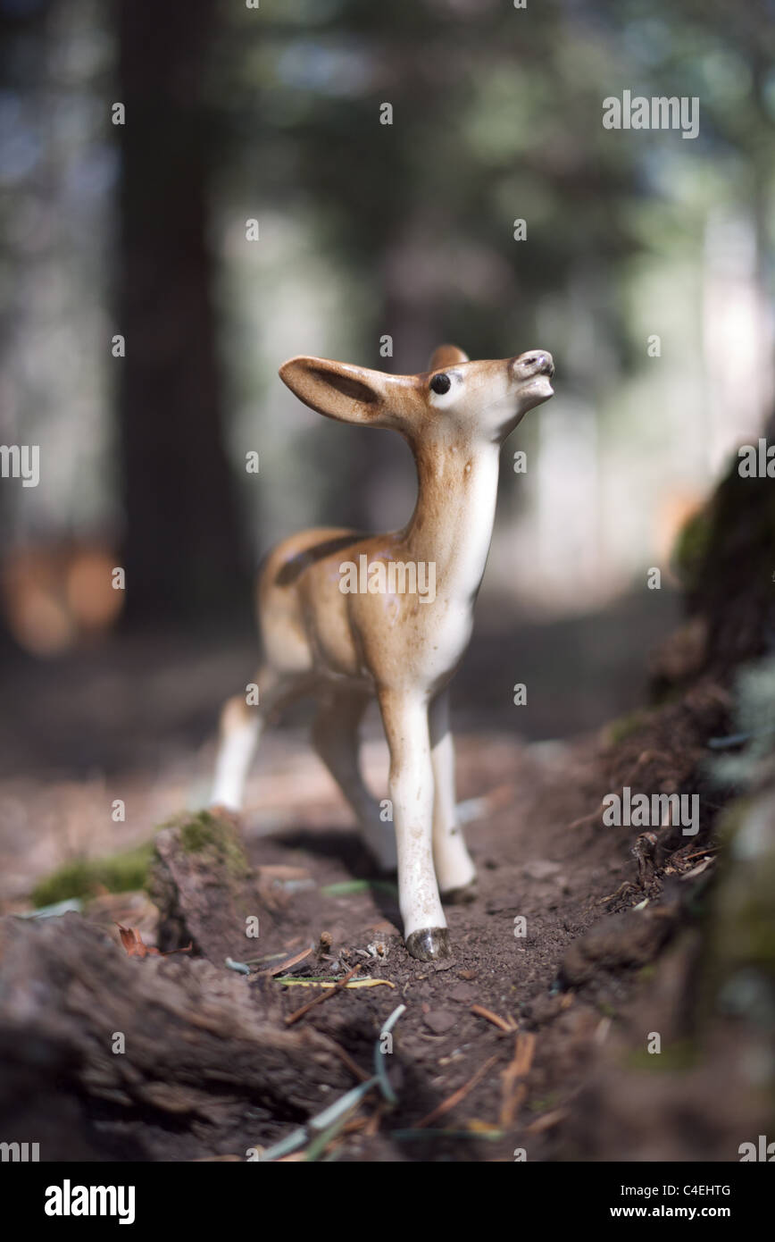 Small deer figurine in woods Stock Photo - Alamy