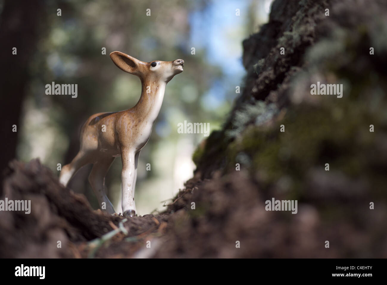 Small deer figurine in woods Stock Photo - Alamy