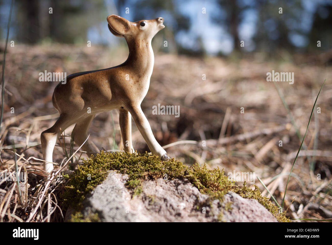 Small deer figurine in woods Stock Photo - Alamy