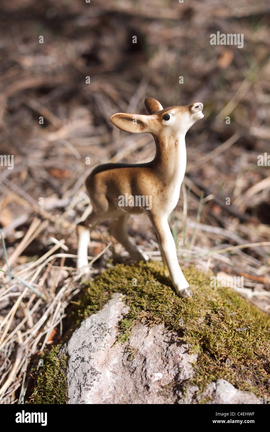 Small deer figurine in woods Stock Photo - Alamy