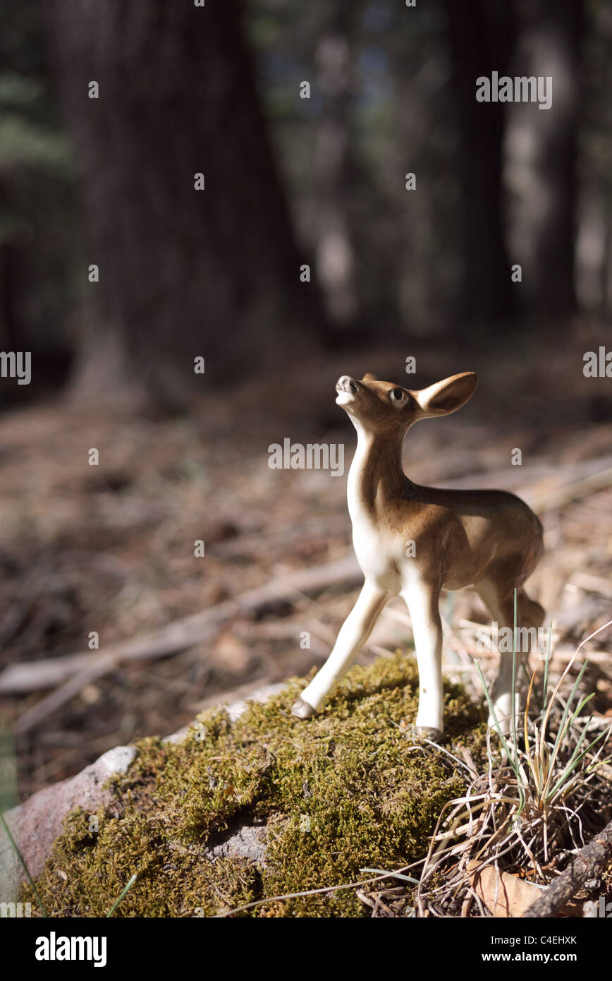 Small deer figurine in woods Stock Photo - Alamy