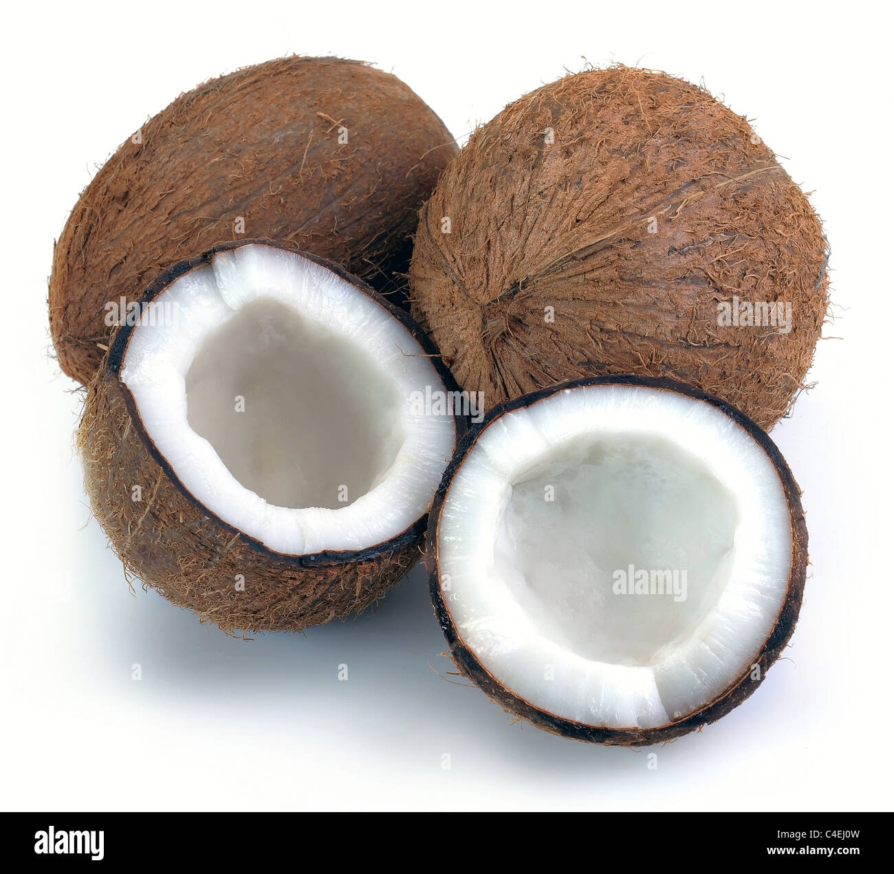 two halves and two entire coconut on white background Stock Photo - Alamy