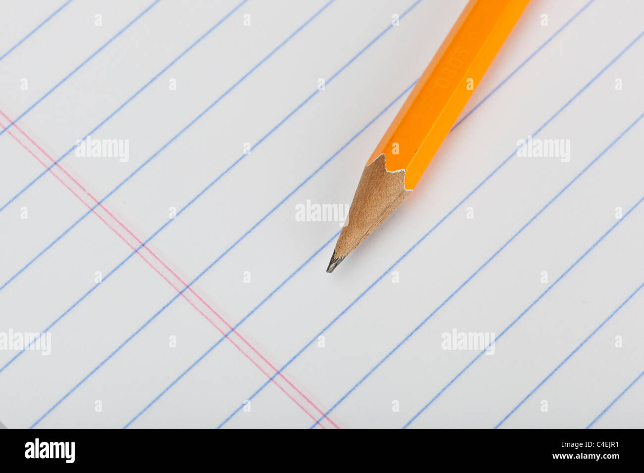 A yellow pencil on a notebook Stock Photo - Alamy