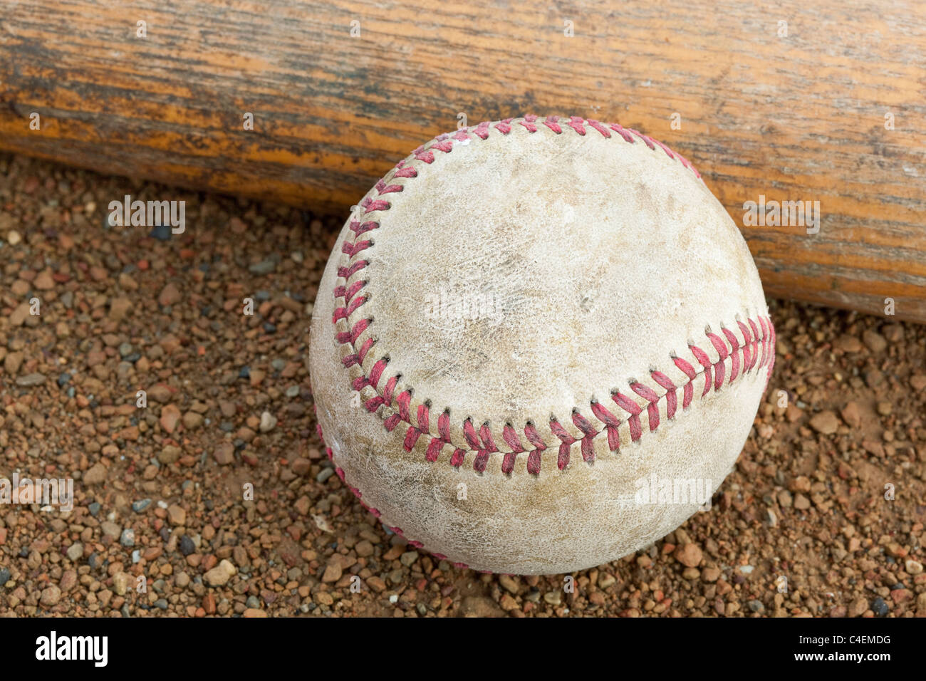 An old worn baseball and bat on a baseball field Stock Photo - Alamy