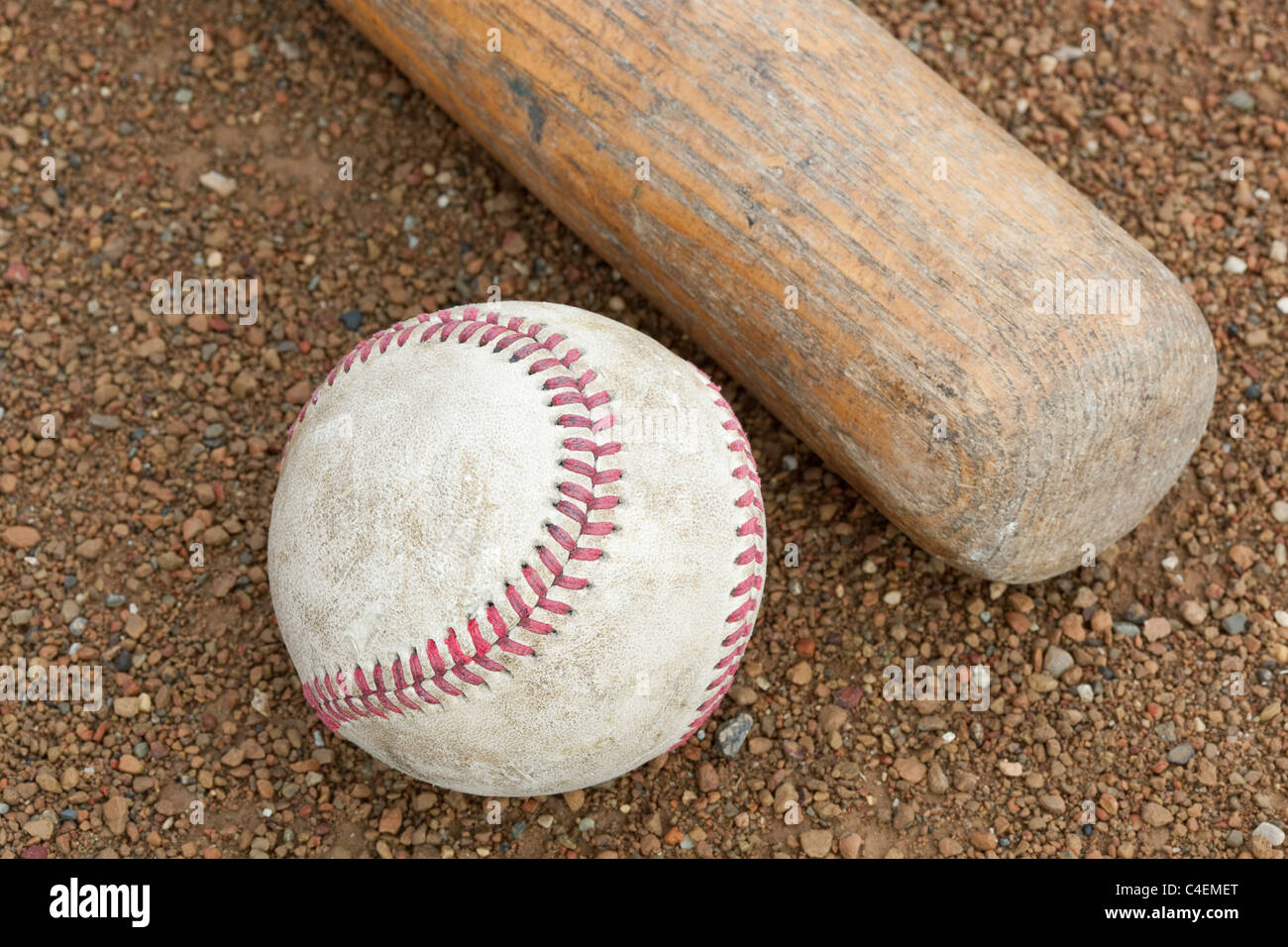 An old worn baseball and bat on a baseball field Stock Photo - Alamy