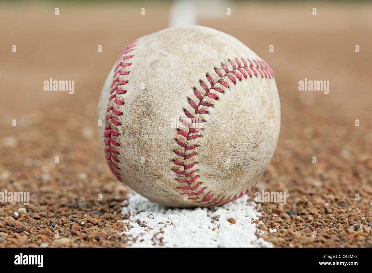 An old worn baseball on a baseball field Stock Photo - Alamy