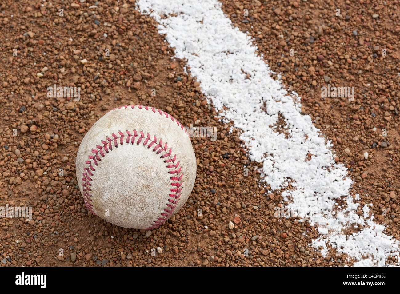 An old worn baseball on a baseball field Stock Photo - Alamy