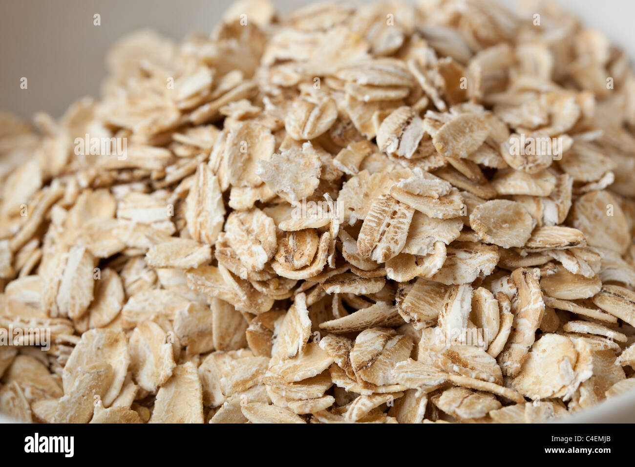 Dry oatmeal against a white background Stock Photo - Alamy