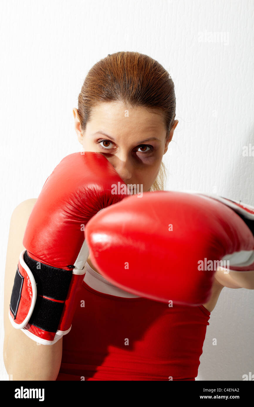 Portrait of young woman in red boxing gloves looking at camera Stock ...