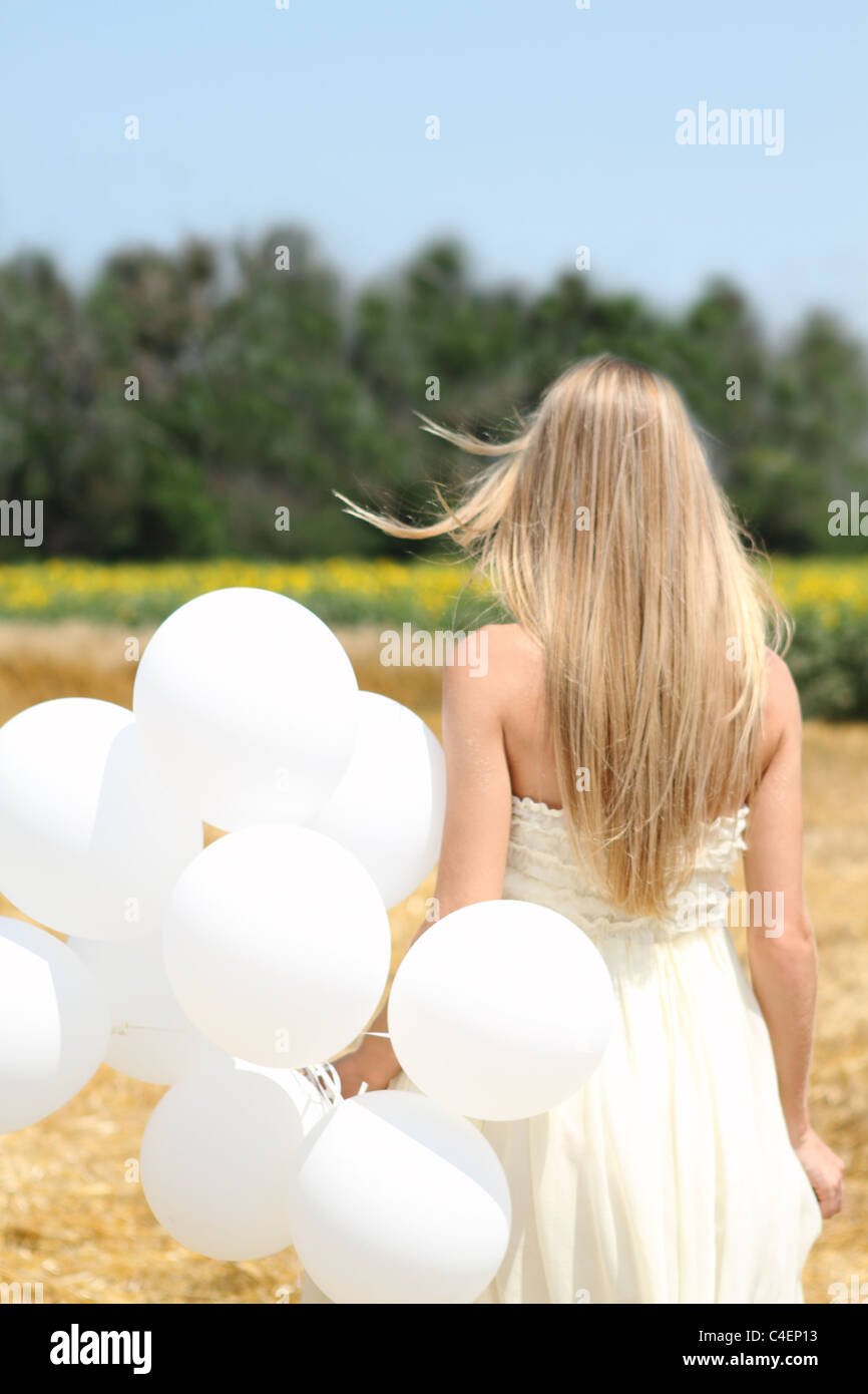 Girl with white balloons Stock Photo - Alamy