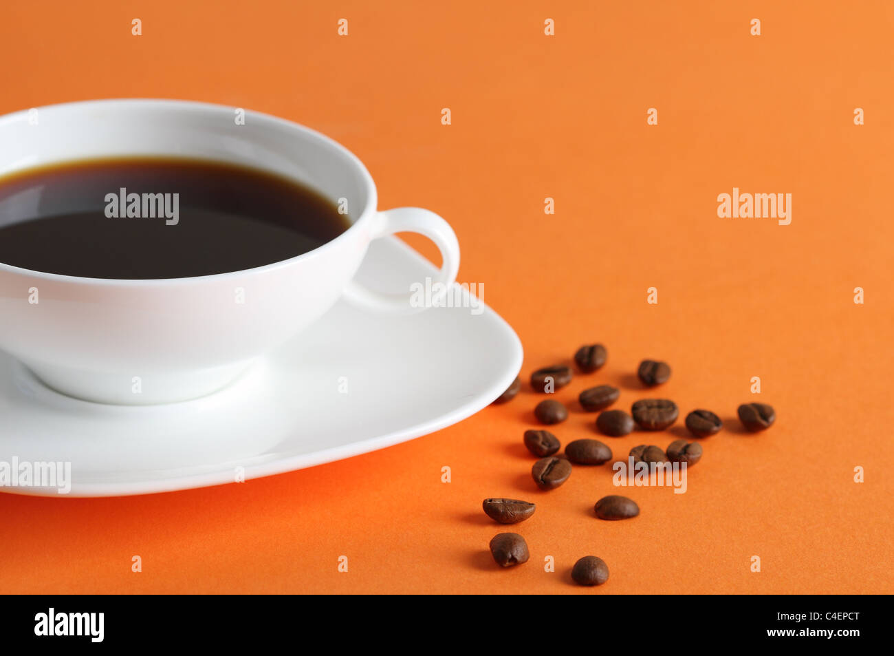 Coffee on the orange background Stock Photo - Alamy