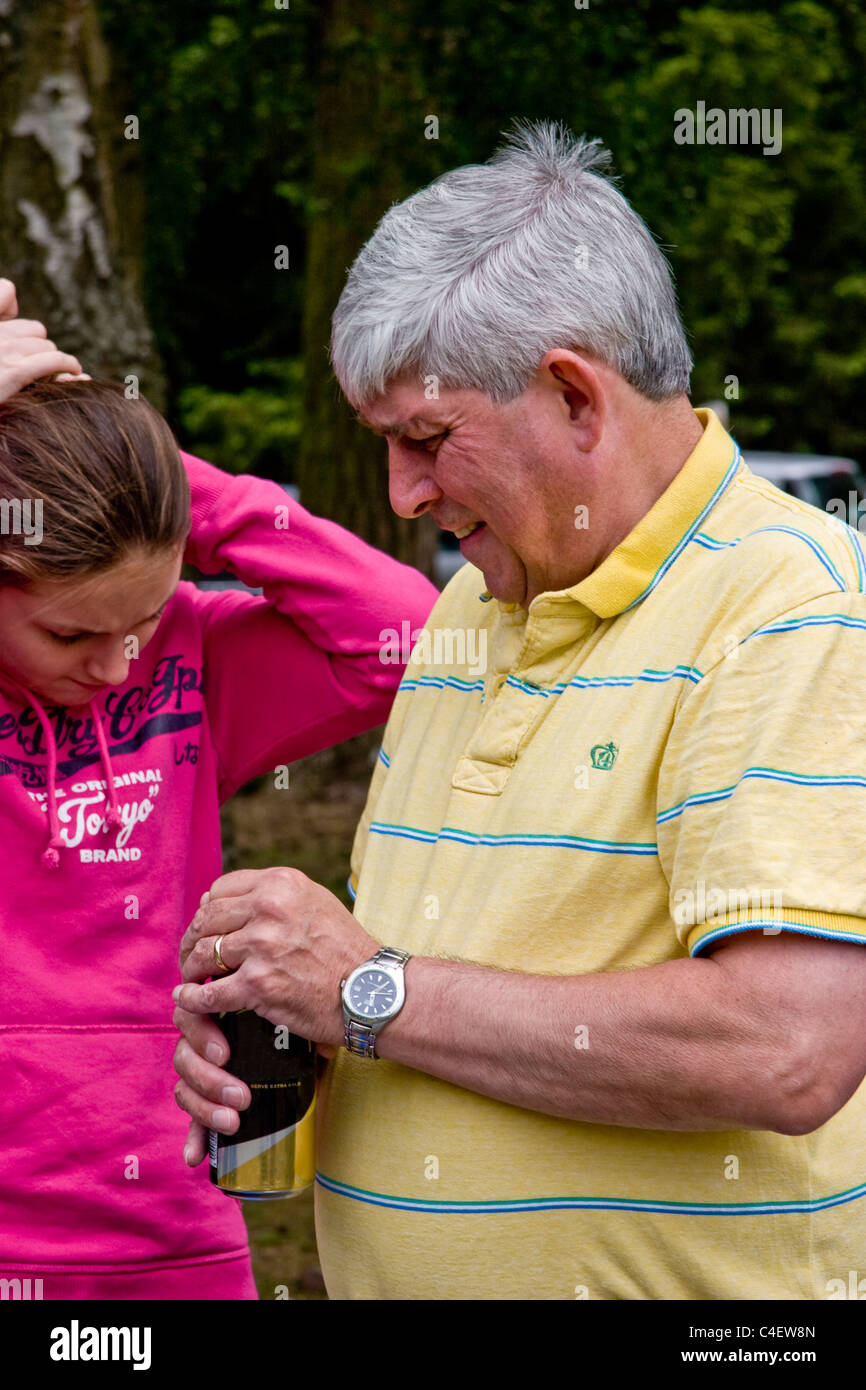 Mature man drinking cider from a can at a picnic Stock Photo - Alamy