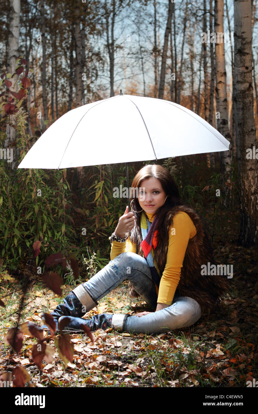 Brunette girl under light umbrella Stock Photo - Alamy