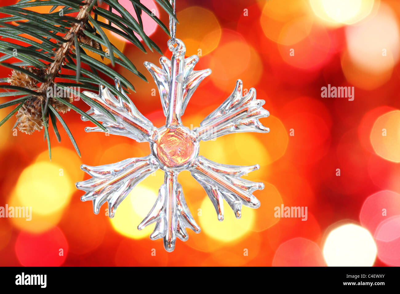 Snowflake on branch of Christmas tree Stock Photo - Alamy