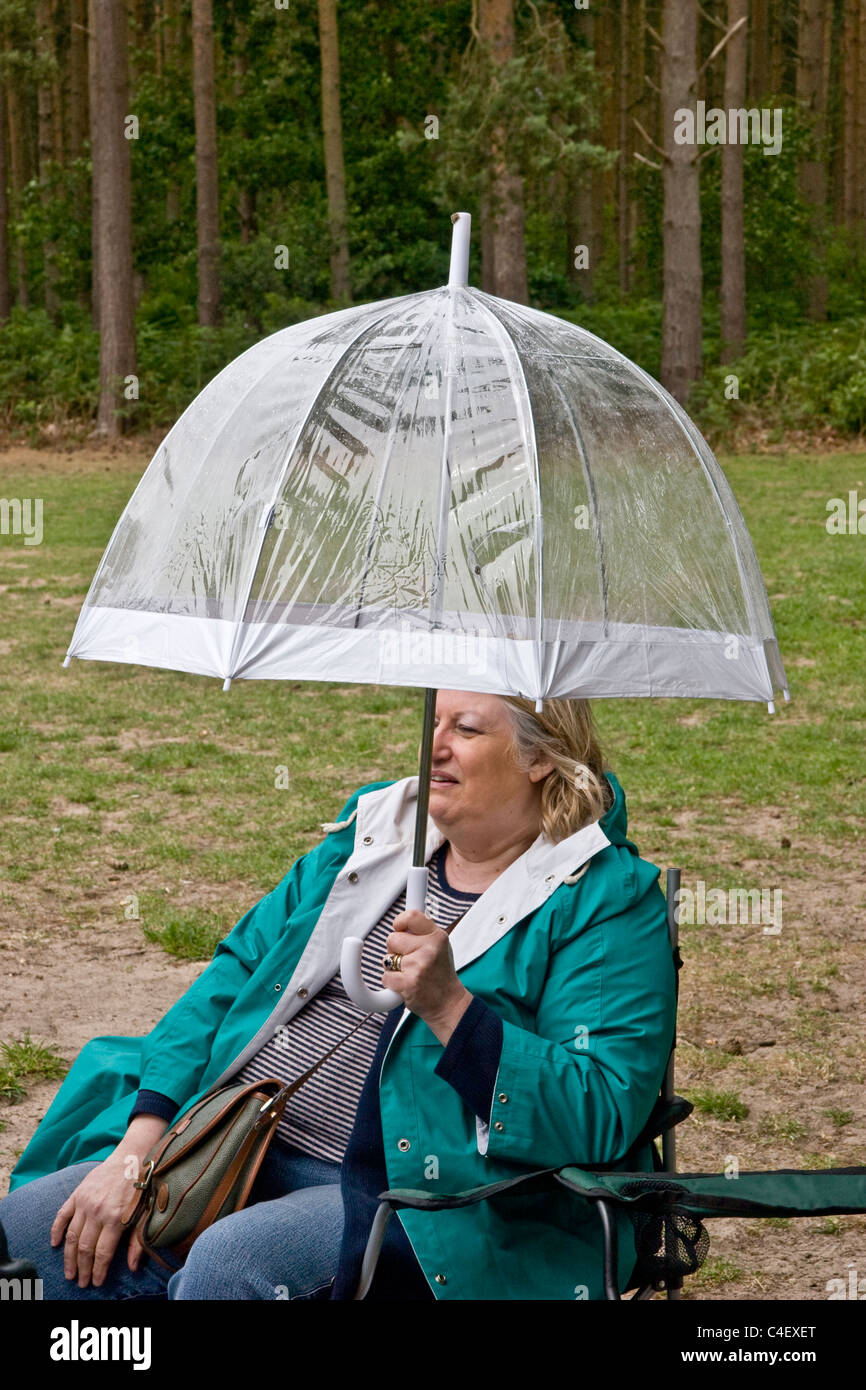 Woman with umbrella at a picnic in the rain Stock Photo - Alamy