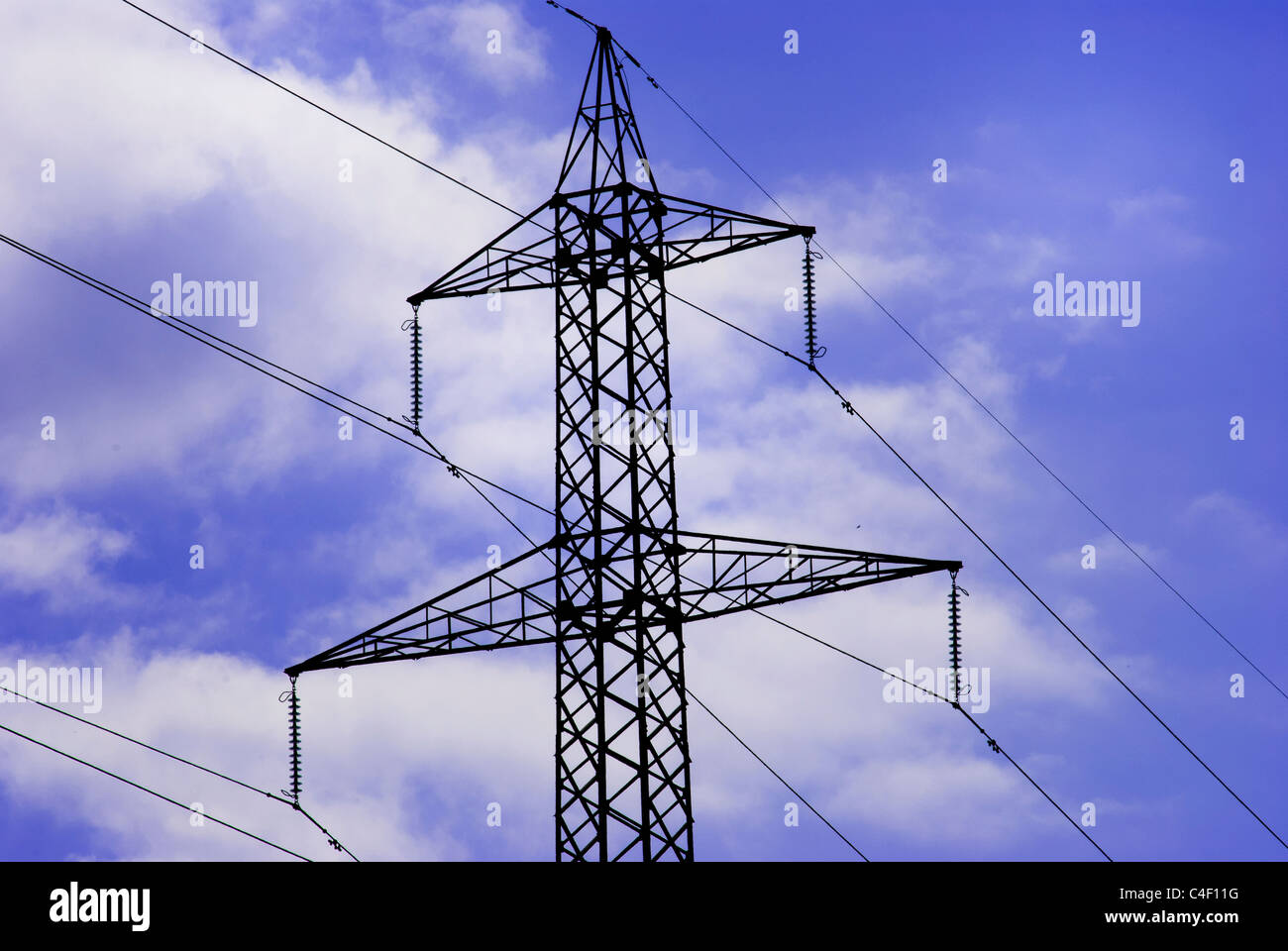 Electricity pylons with long cable at day Stock Photo - Alamy
