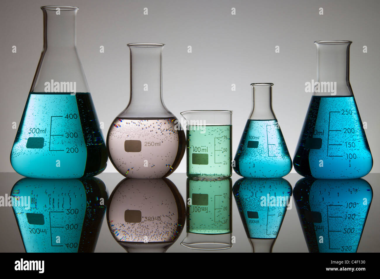 five laboratory flasks with liquid and a white background Stock Photo ...