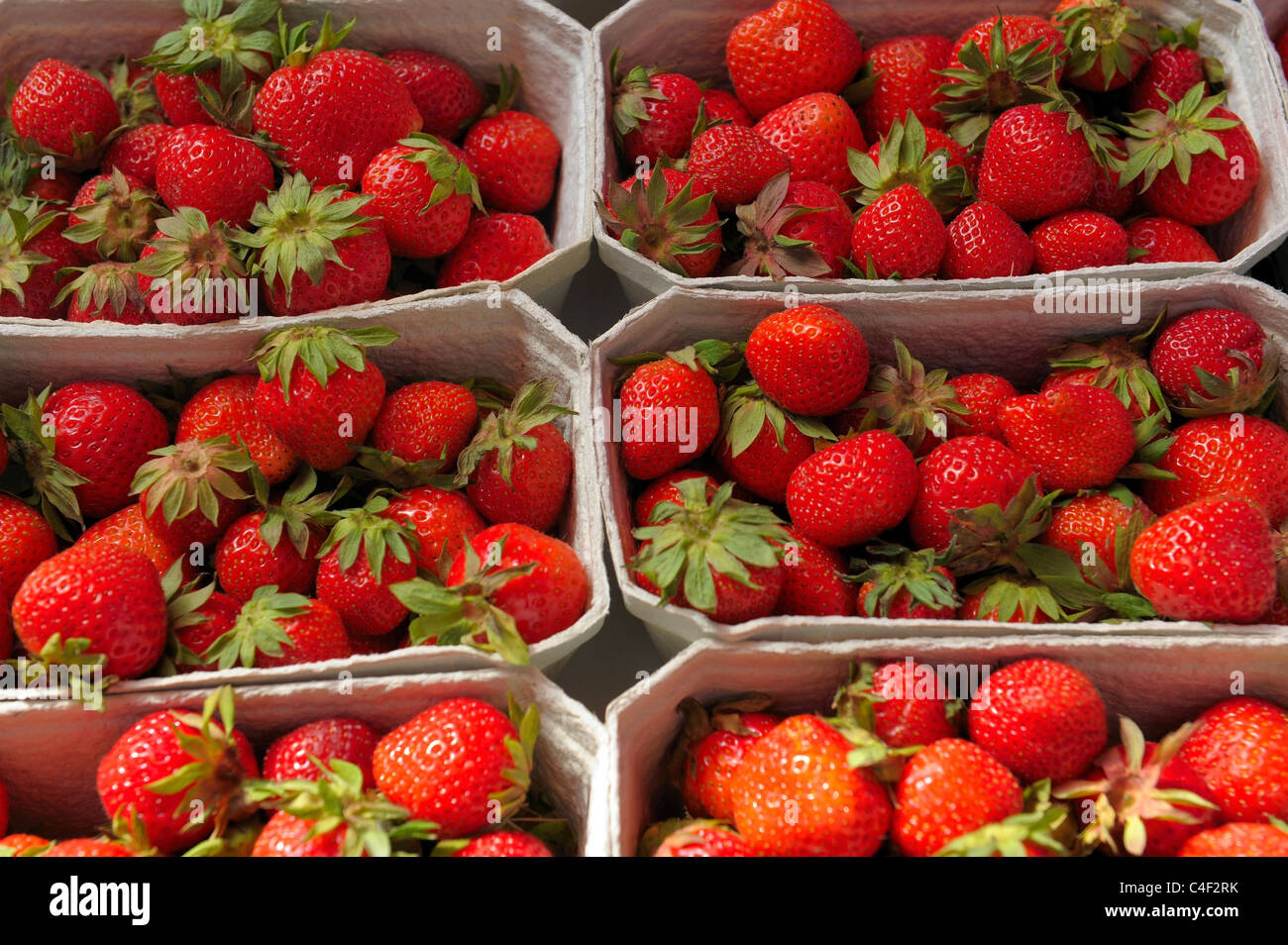 Strawberry in small containers on a shop counter Stock Photo - Alamy