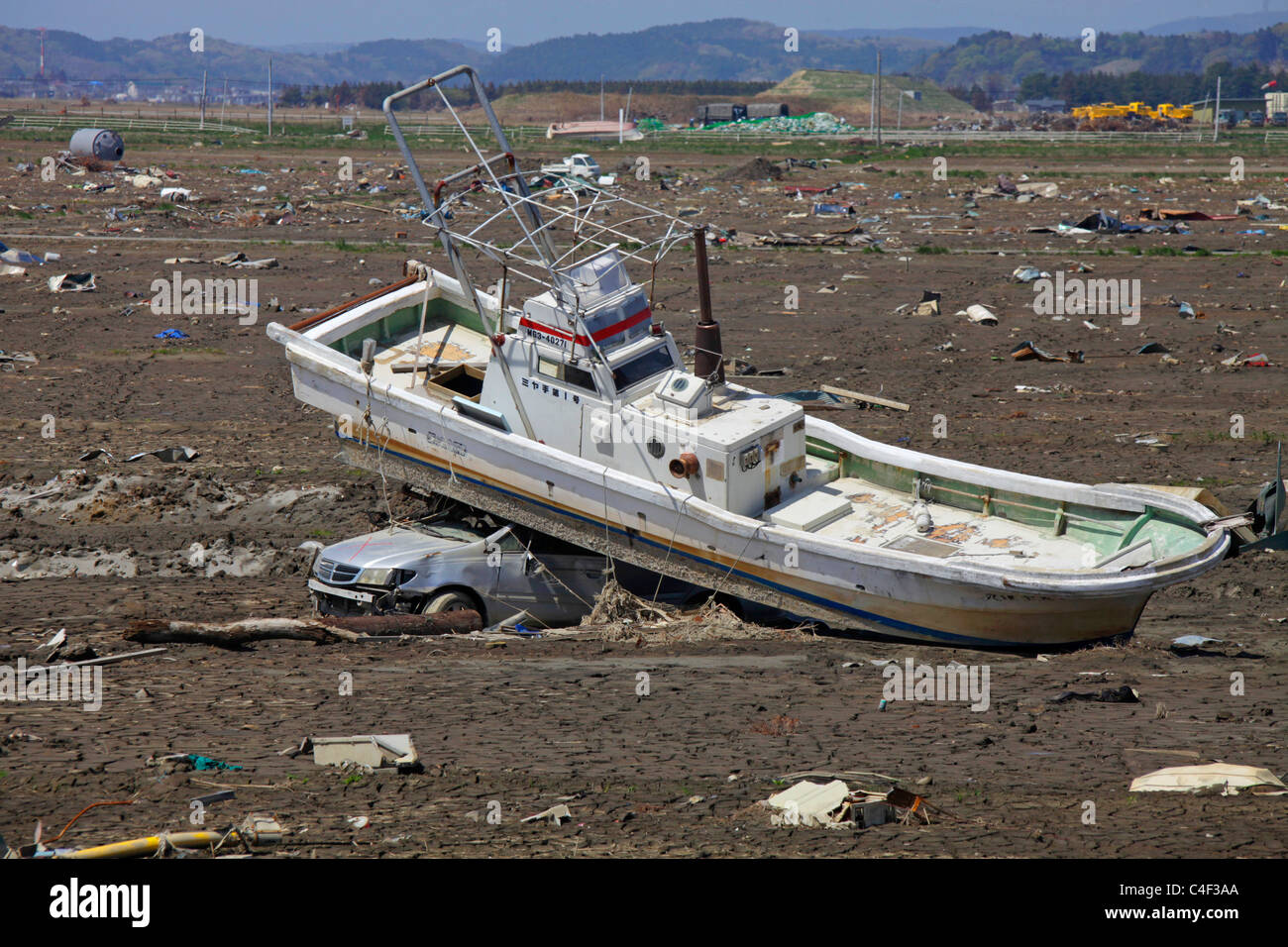 Tsunami fishing boat on a top of a car near Ishinomaki port Miyagi ...