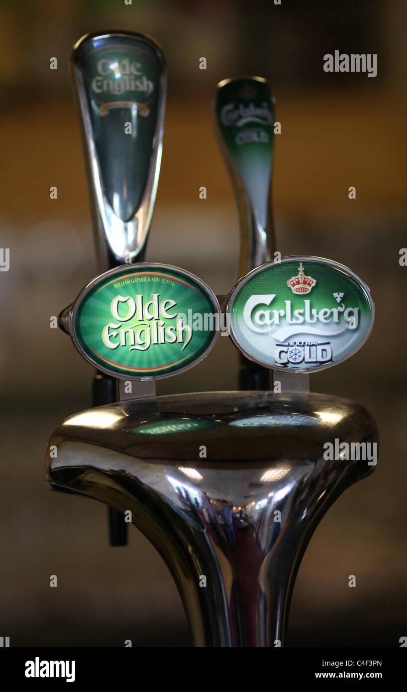 A woman pours Draft beer from a pump. Picture by James Boardman Stock ...