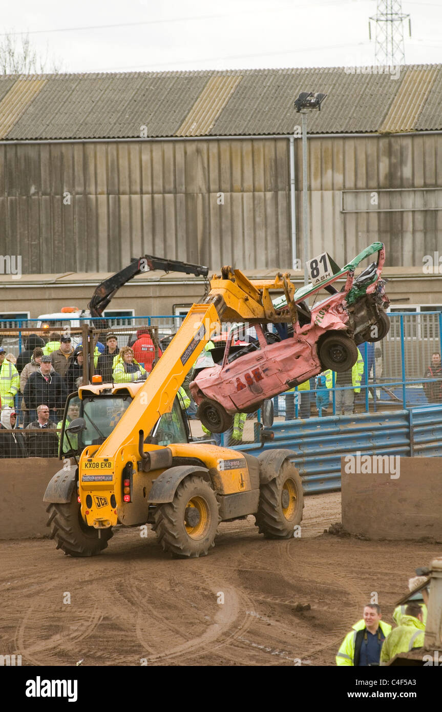 jcb lifting car of track after a banger race Stock Photo - Alamy