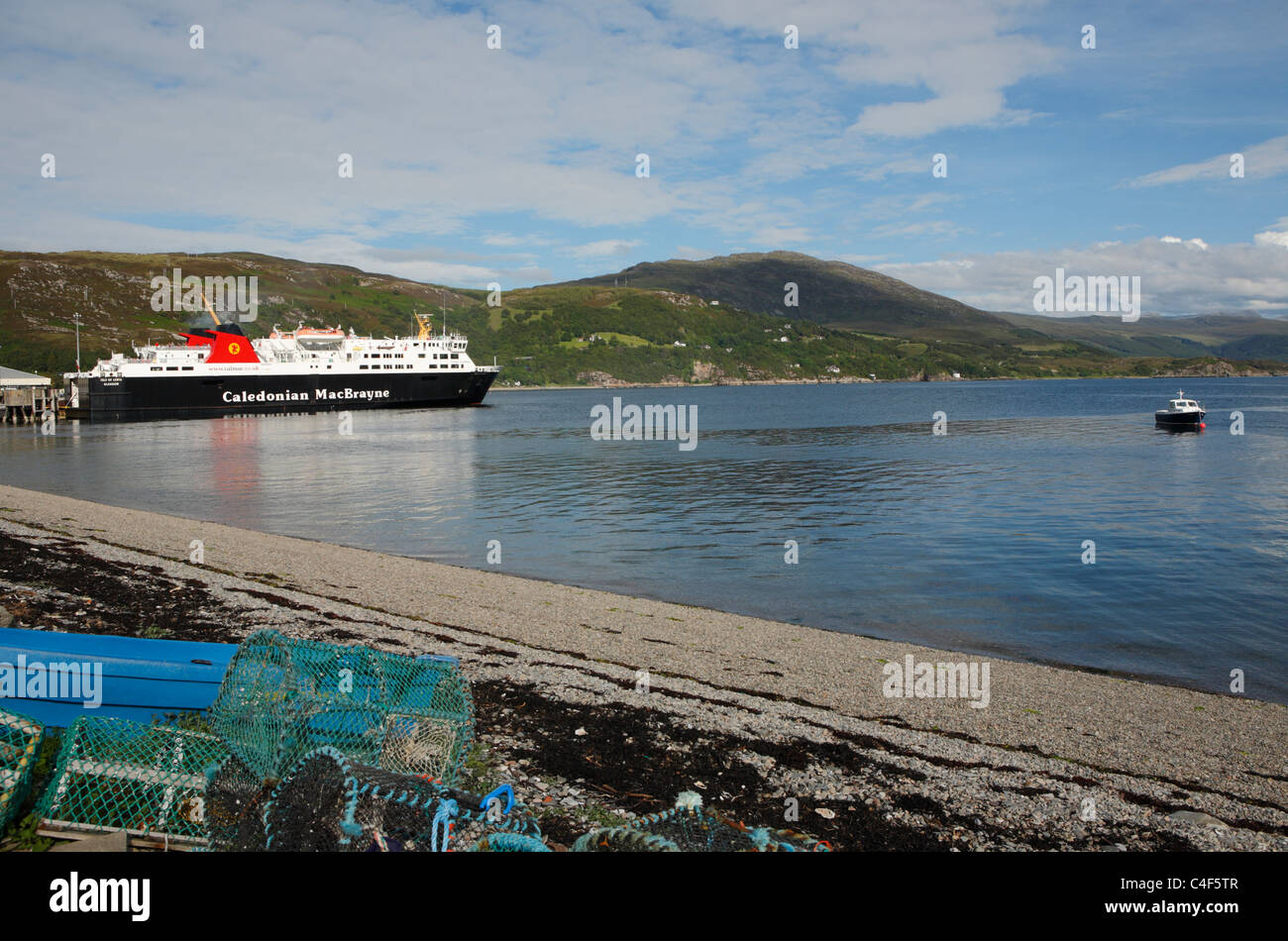 The Caledonian MacBrayne ferry at Ullapool with mountains behind and ...