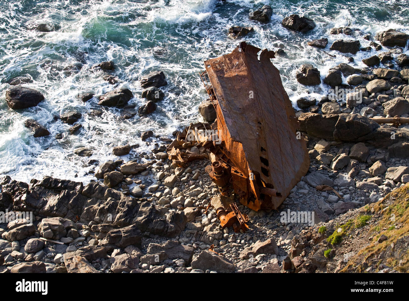 Rusting iron ship keel hulk on the shoreline Remains of Shipwreck at ...