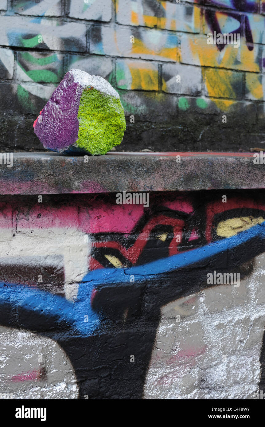 Graffiti on stone wall and painted stone Stock Photo - Alamy