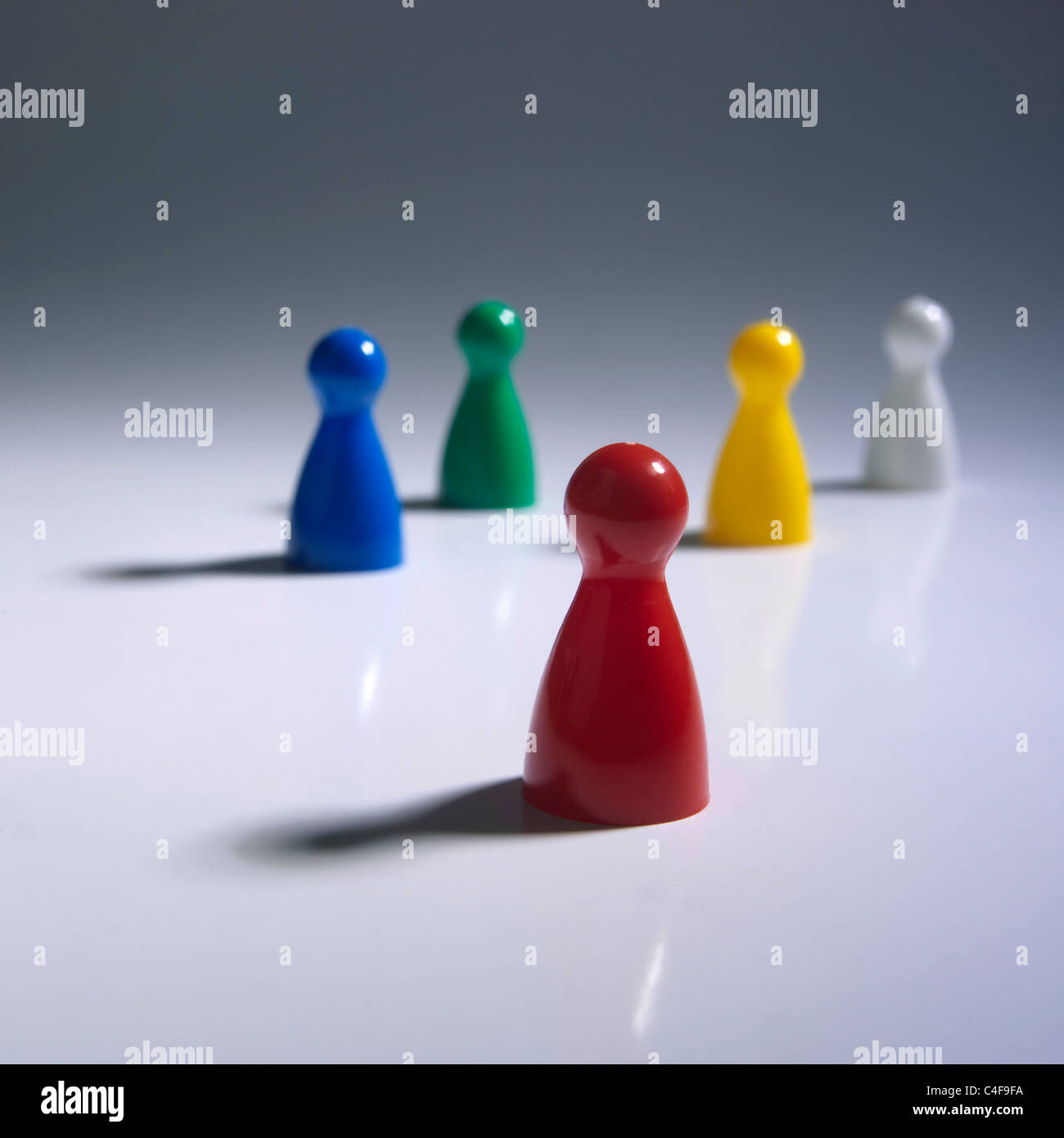 Colorful game pieces arranged in a dynamic composition on a light ...