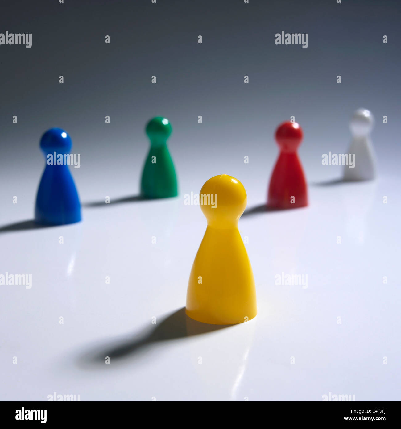 Colorful game pieces arranged in a dynamic composition on a light ...