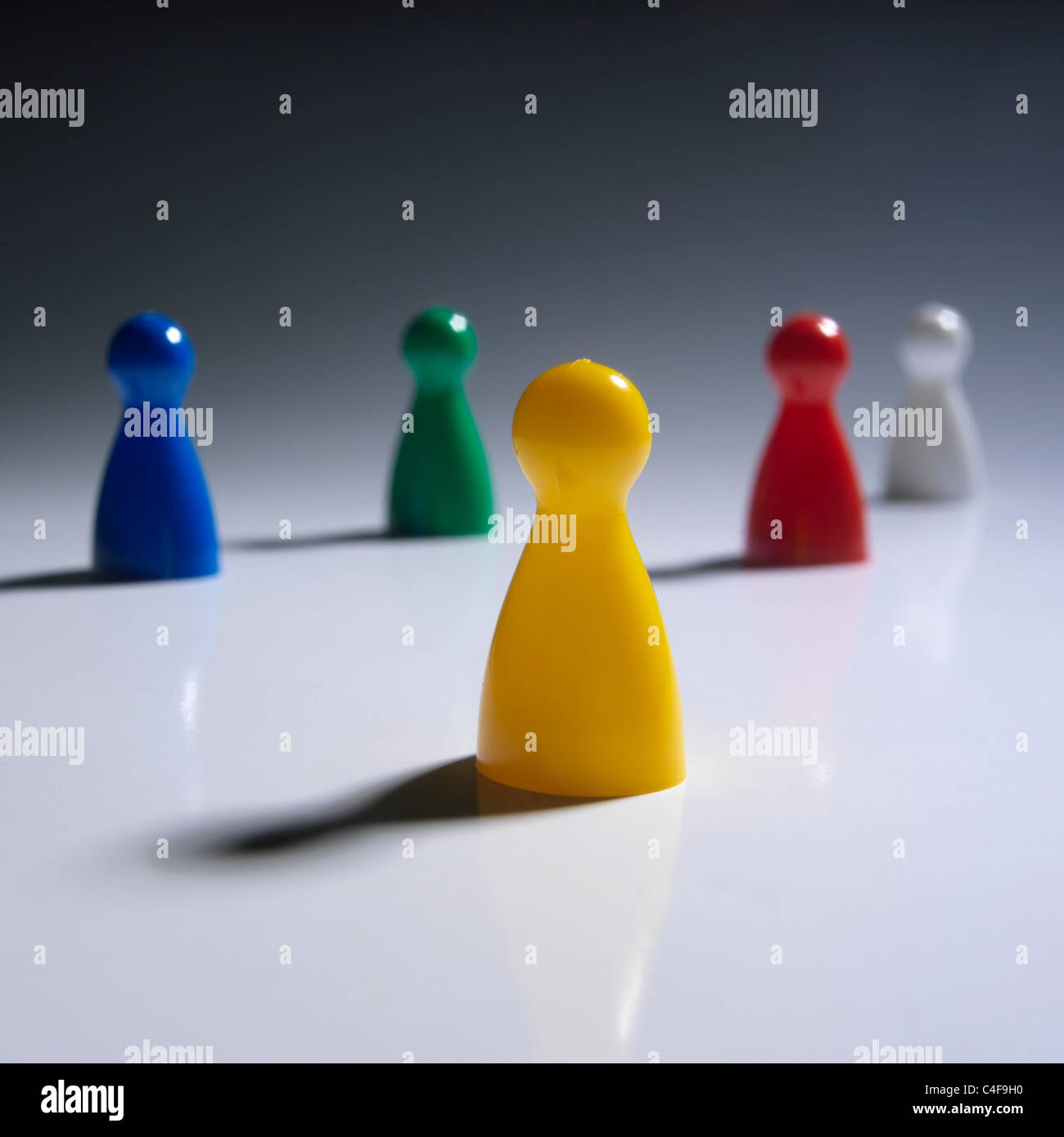 Colorful game pieces arranged in a dynamic composition on a light ...